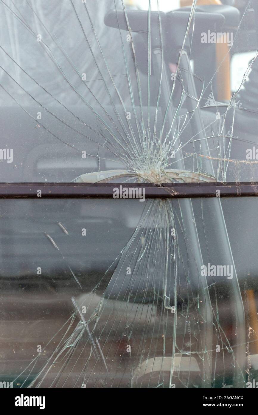 A close up view of the broken window of a large gradder on the beach ...