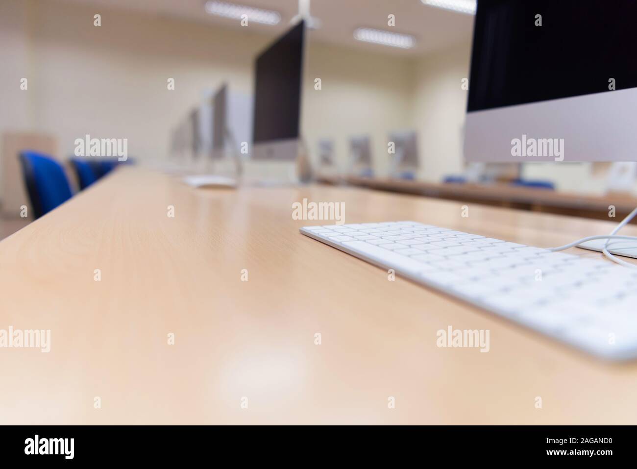 Modern office with computers on desks. Empty computer room in college ...