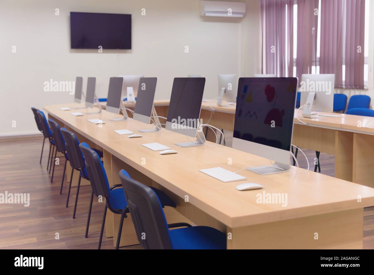Modern office with computers on desks. Empty computer room in college ...