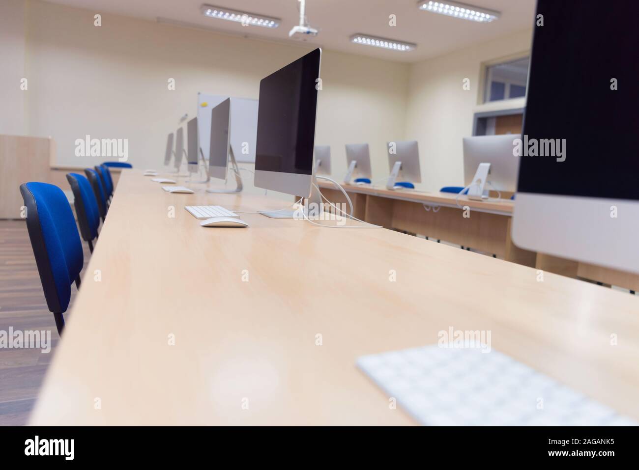 Modern office with computers on desks. Empty computer room in college ...