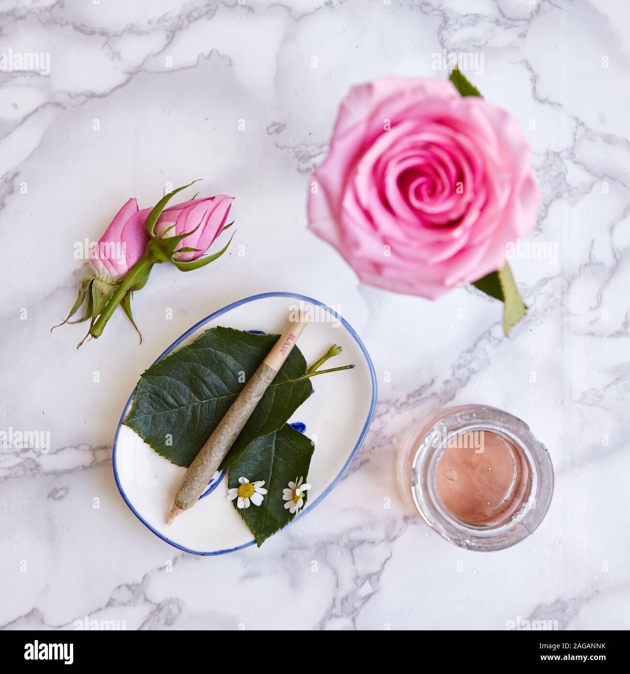 Marijuana Joint with Rose and Drink Stock Photo - Alamy