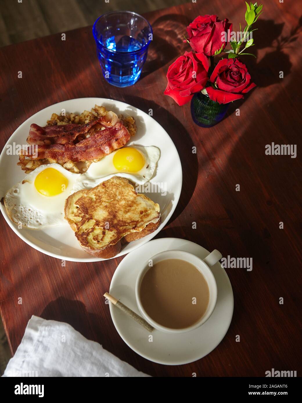 Vertical high angle shot of breakfast with eggs and bacon in a plate ...