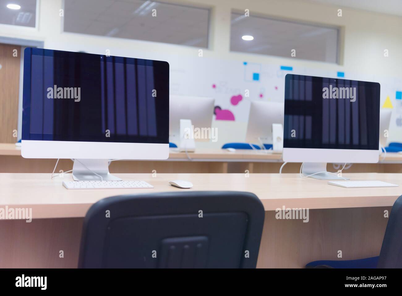 Modern office with computers on desks. Empty computer room in college ...