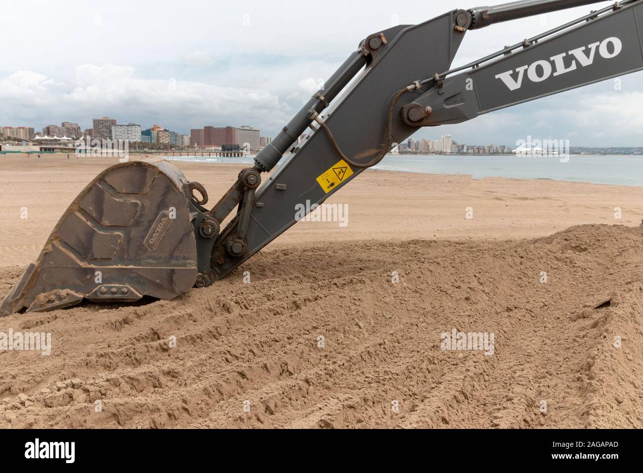 A close up view of a volvo grader digging up sand on Durban beach Stock ...