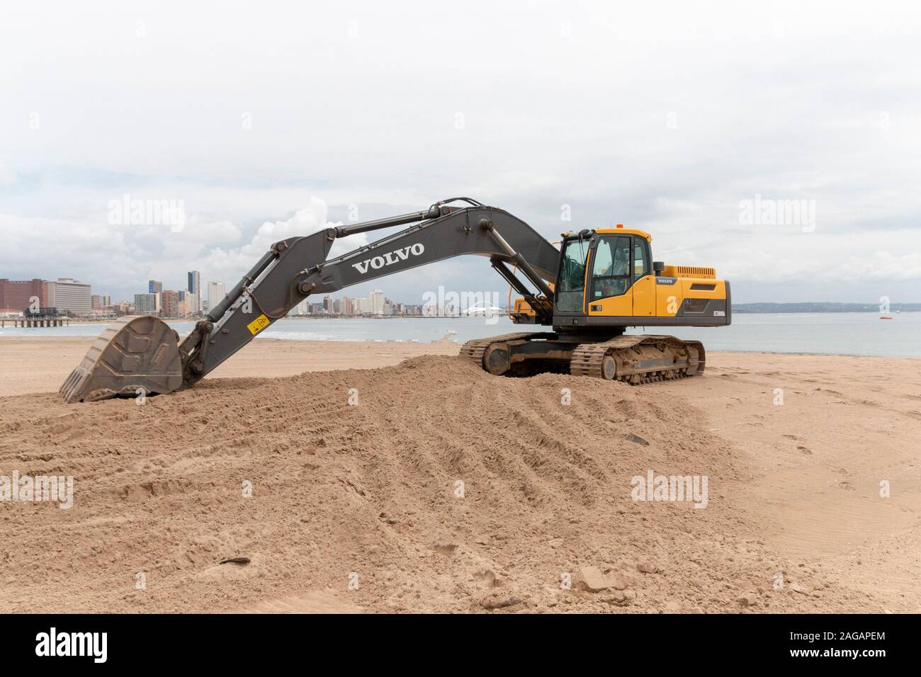 A close up view of a volvo grader digging up sand on Durban beach Stock ...