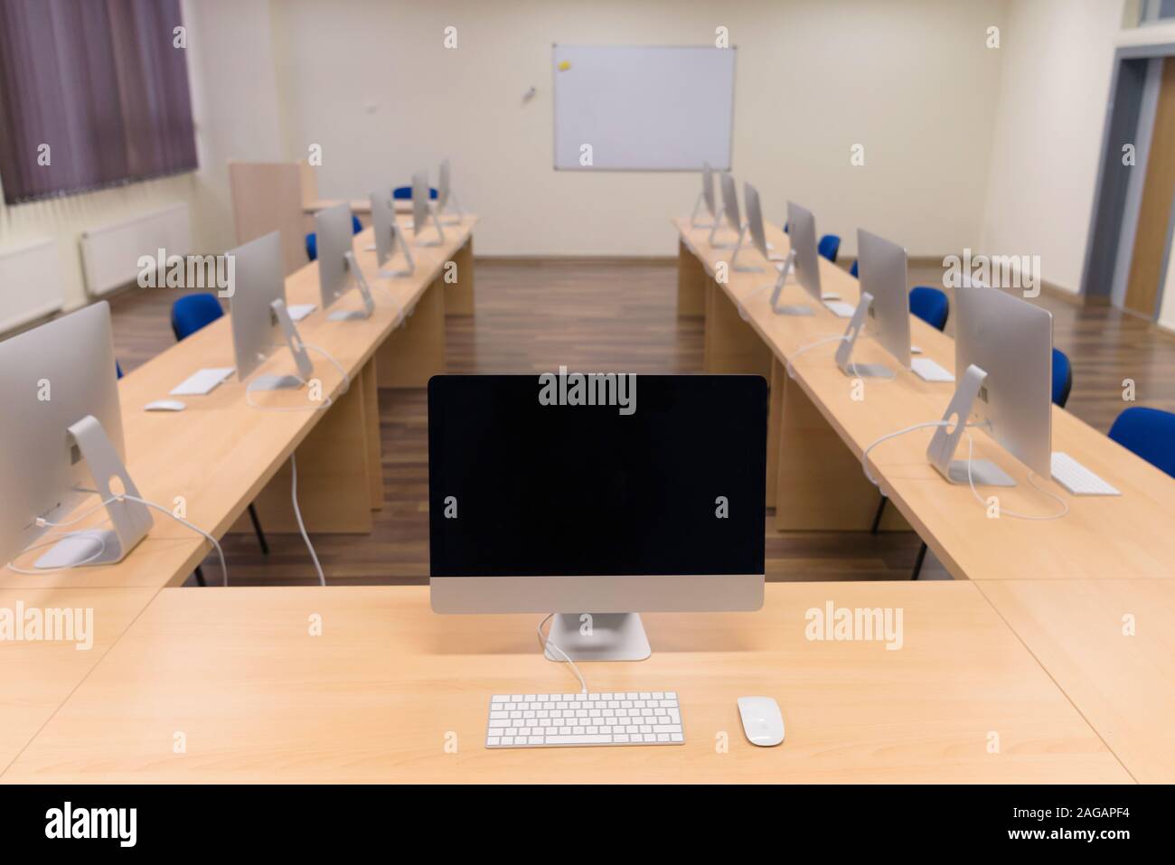 Modern office with computers on desks. Empty computer room in college ...