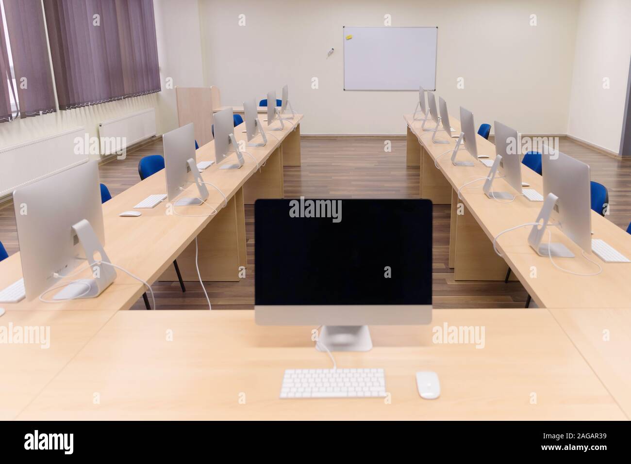 Modern office with computers on desks. Empty computer room in college ...