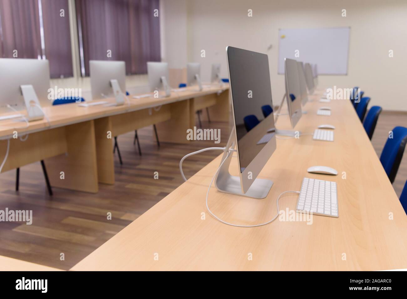 Modern office with computers on desks. Empty computer room in college ...