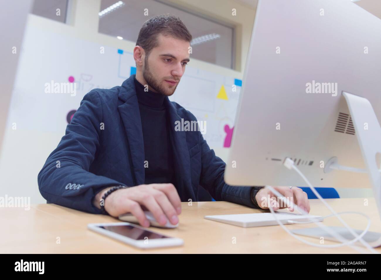 Young male Businessman working on modern computer. Businessman using ...