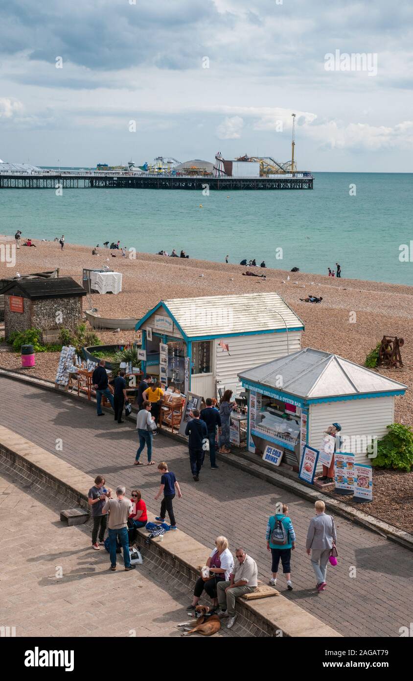 The promenade and stalls on Brighton seafront, East Sussex, England ...