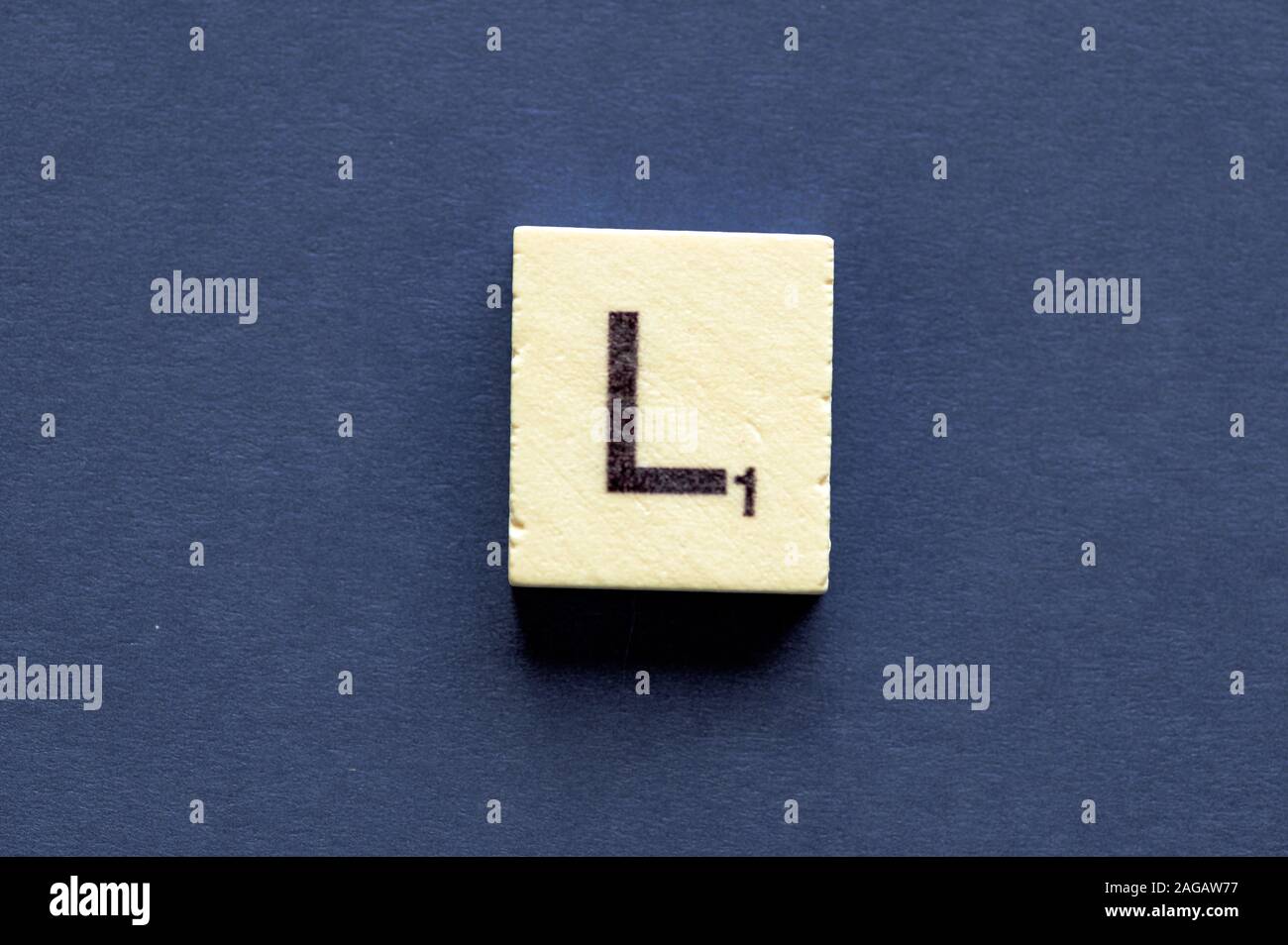 Letter L on a wooden cube from a wordplay board game Stock Photo - Alamy