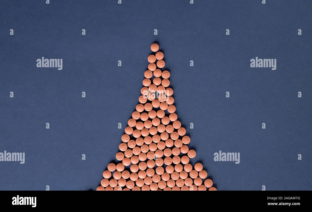 Round pills placed in a triangle shape on a blue background - great for ...