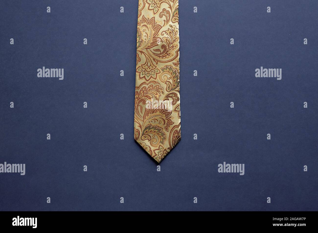 Tie with patterns on a dark blue surface Stock Photo - Alamy