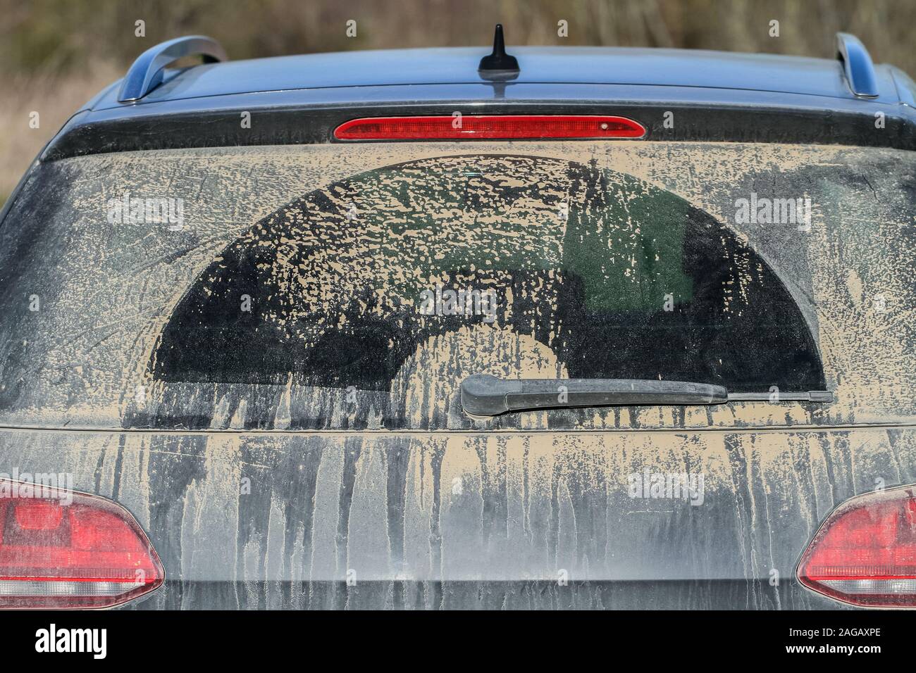 Dirty car in dust, view to the back of window Stock Photo - Alamy