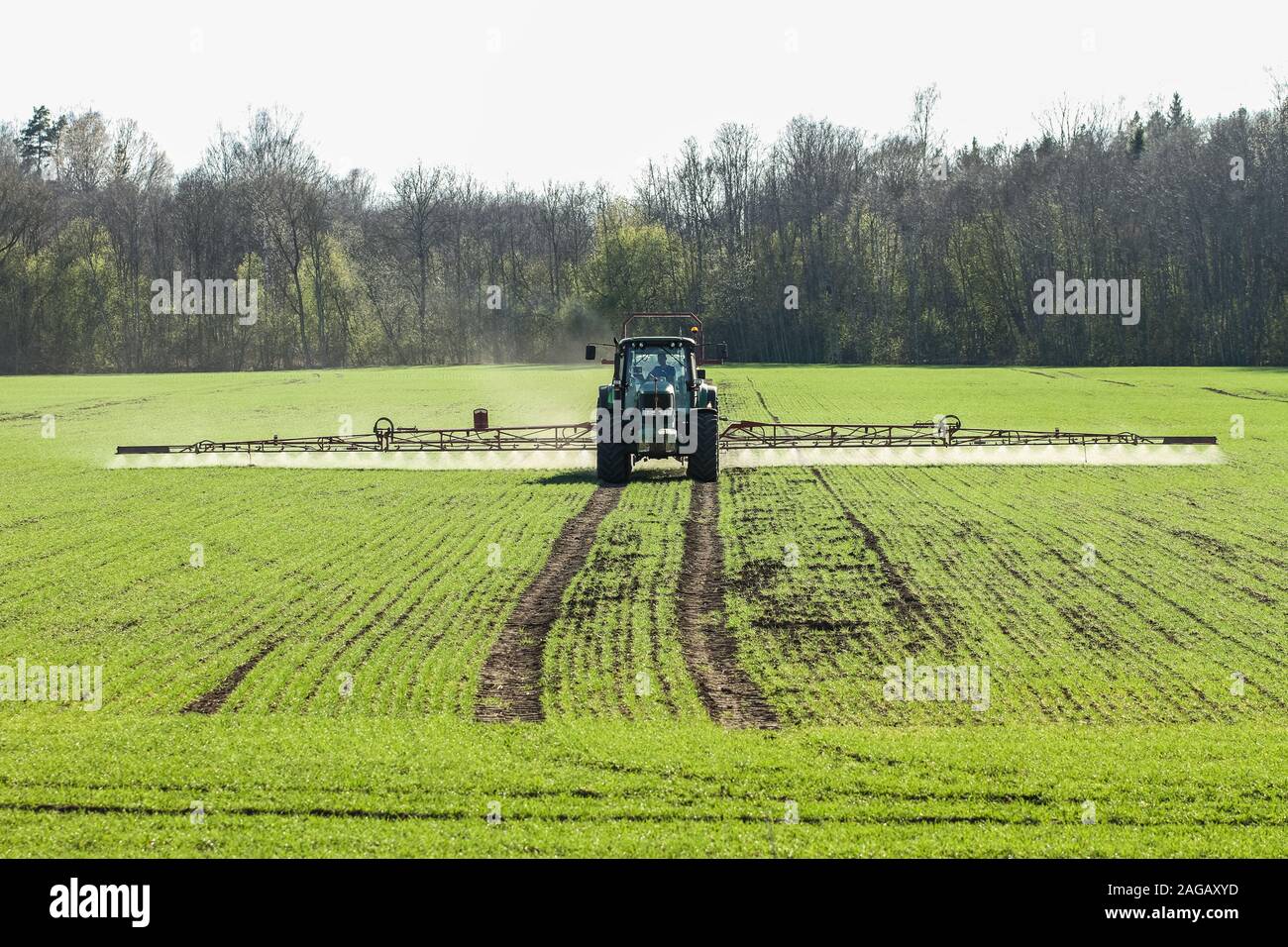Tractor spraying on large green hi-res stock photography and images - Alamy