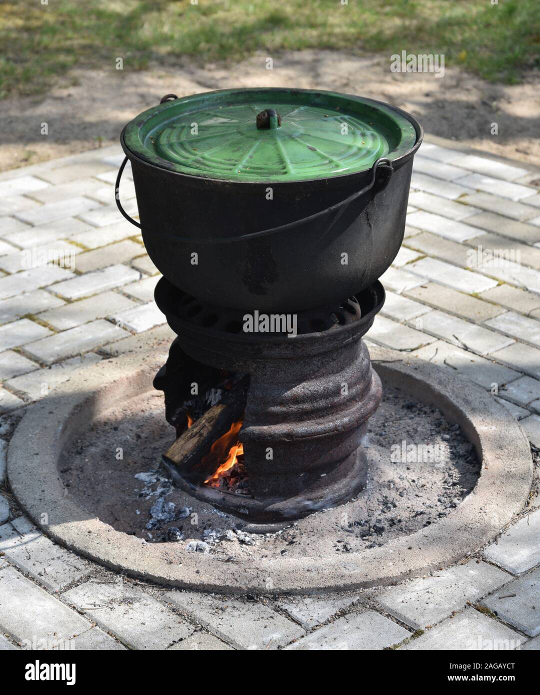 Boiling food in pots using firewood on object from disk of heavy ...