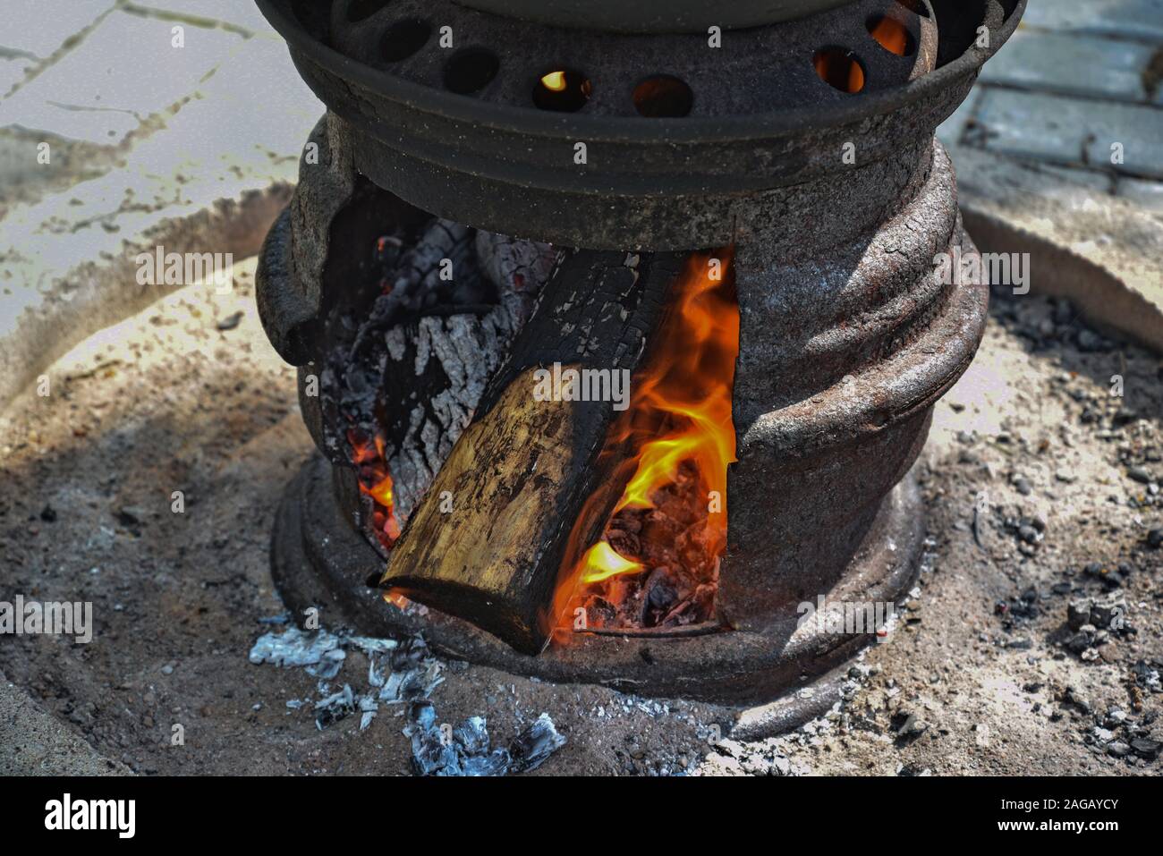 Boiling food in pots using firewood on object from disk of heavy ...