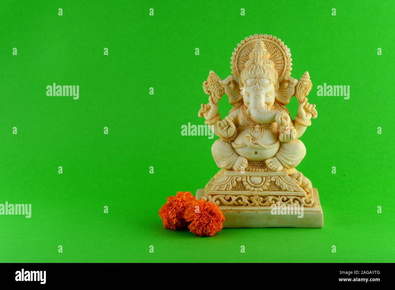 Hindu God Ganesha. Ganesha Idol on green background Stock Photo - Alamy