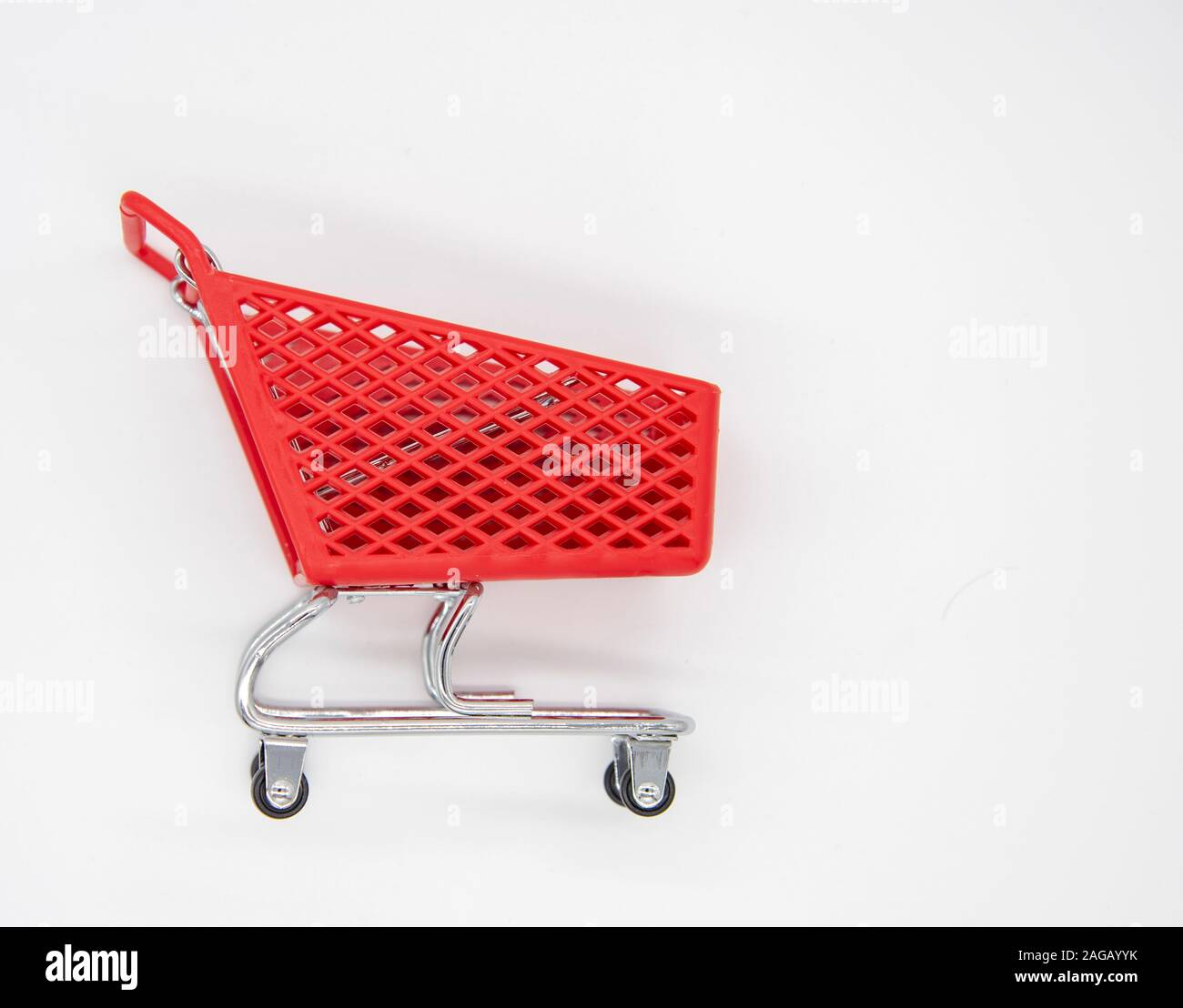 An empty supermarket cart on a light background Stock Photo - Alamy