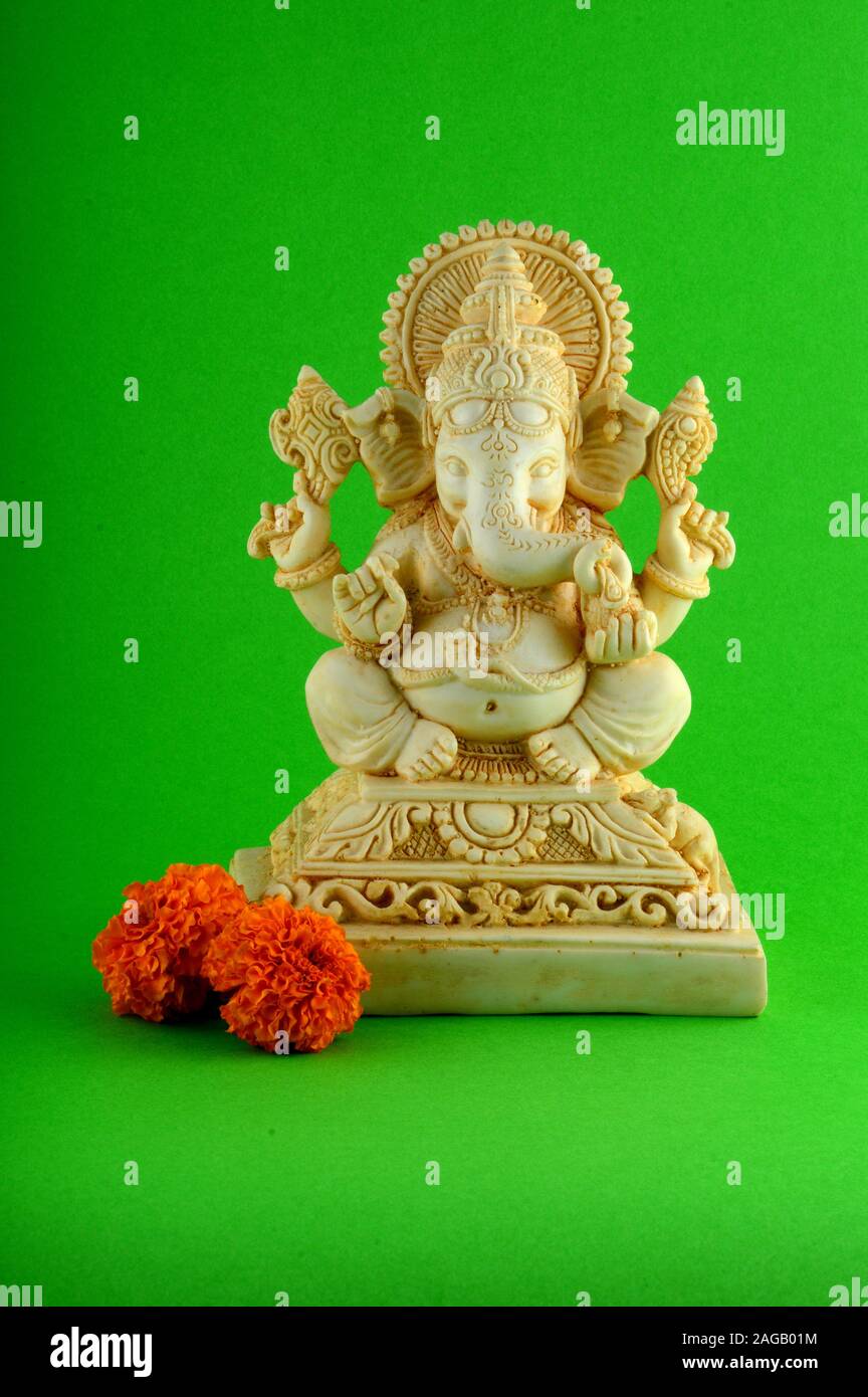Hindu God Ganesha. Ganesha Idol on green background Stock Photo - Alamy