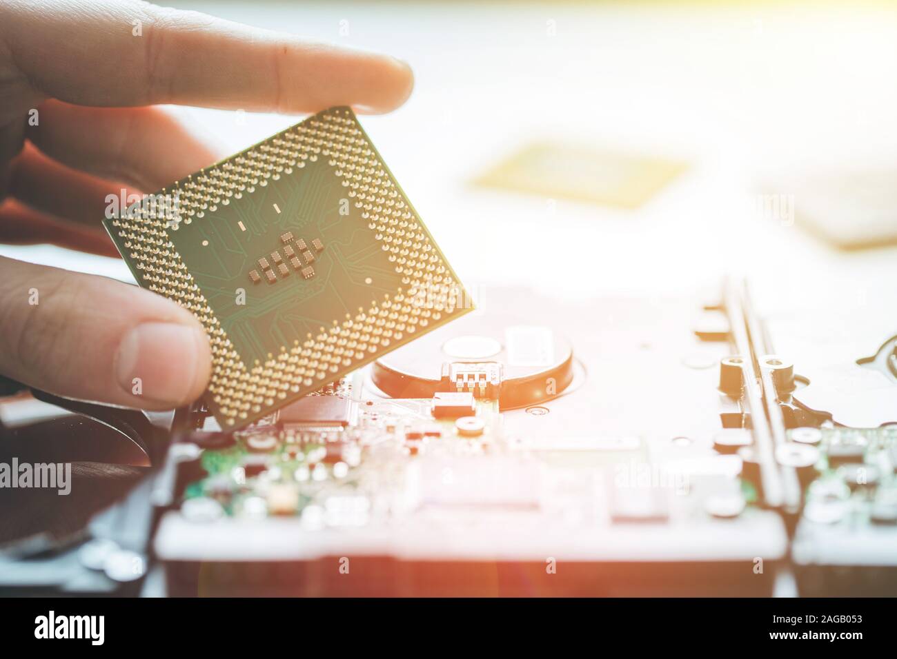 Male hand is holding a cpu, close up; Computer technology. Sunshine ...