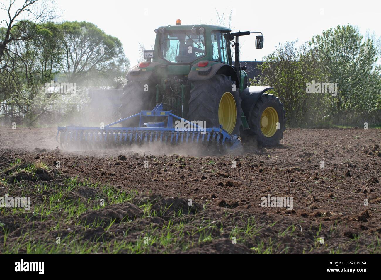LATVIA, TUKUMS - 30 APRIL: Tractor work on the field in a springtime ...