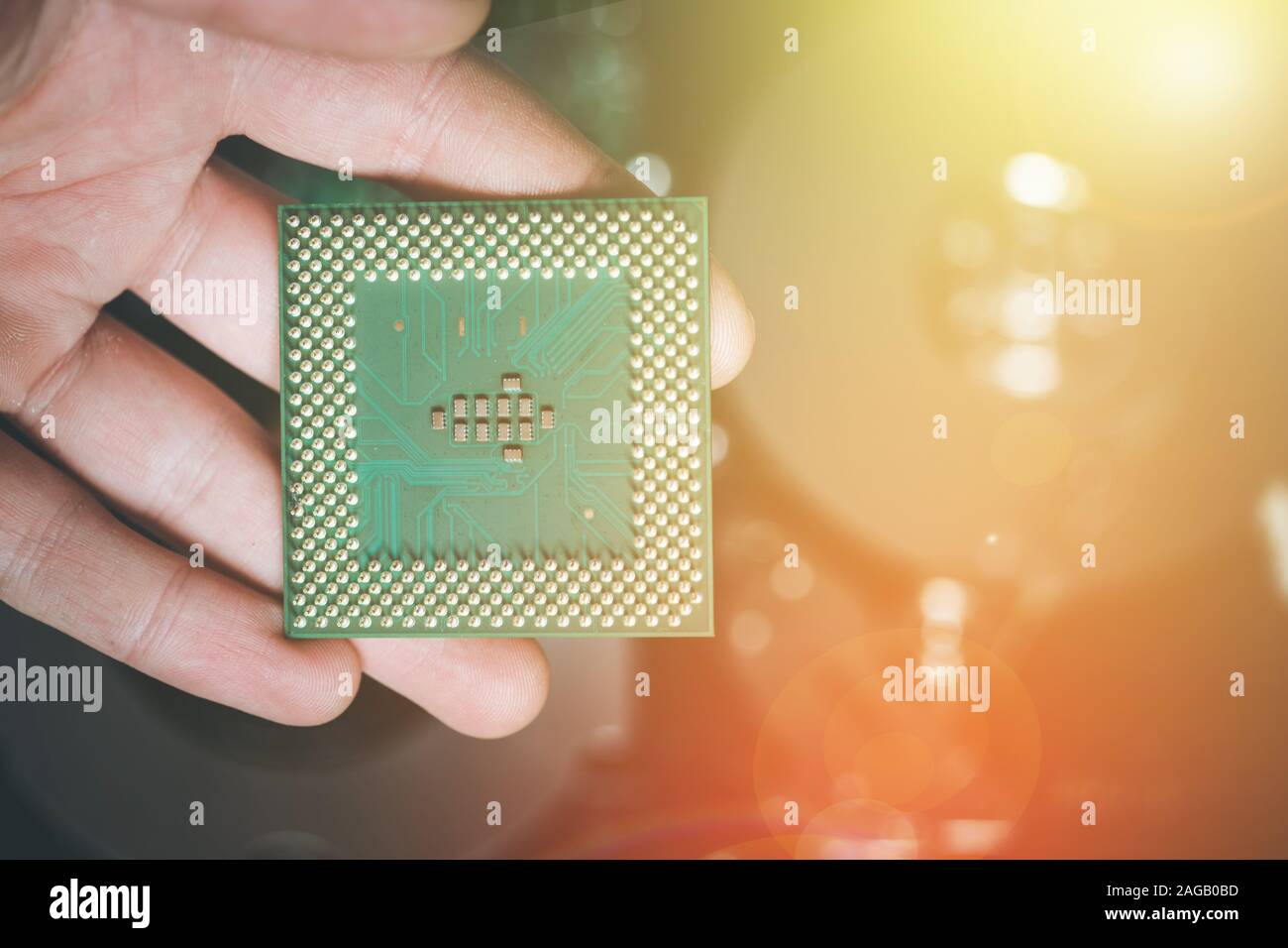 Male hand is holding a cpu, close up; Computer technology. Sunshine ...