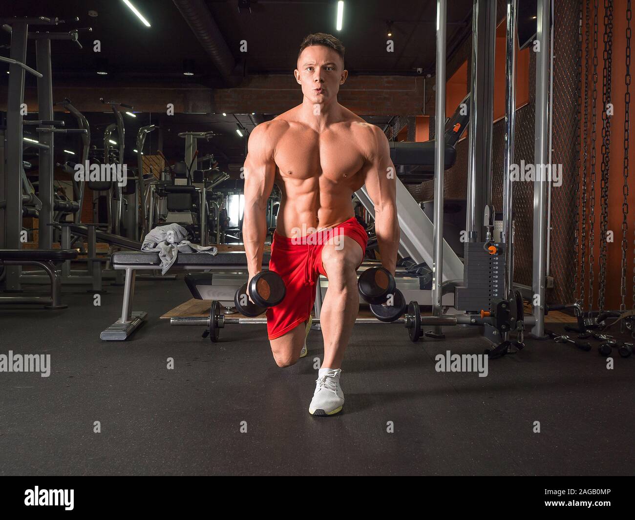 Middle aged man doing exercise for legs. Man working out legs with ...