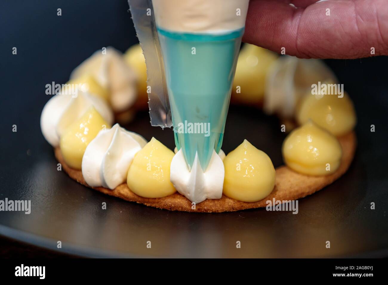 Closeup shot of a person making a delicious dessert with sweet cream ...