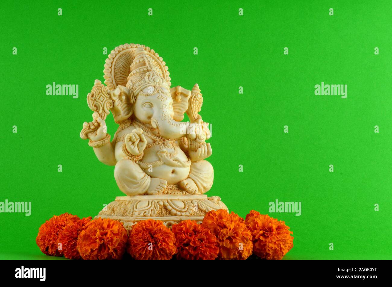 Hindu God Ganesha. Ganesha Idol on green background Stock Photo - Alamy