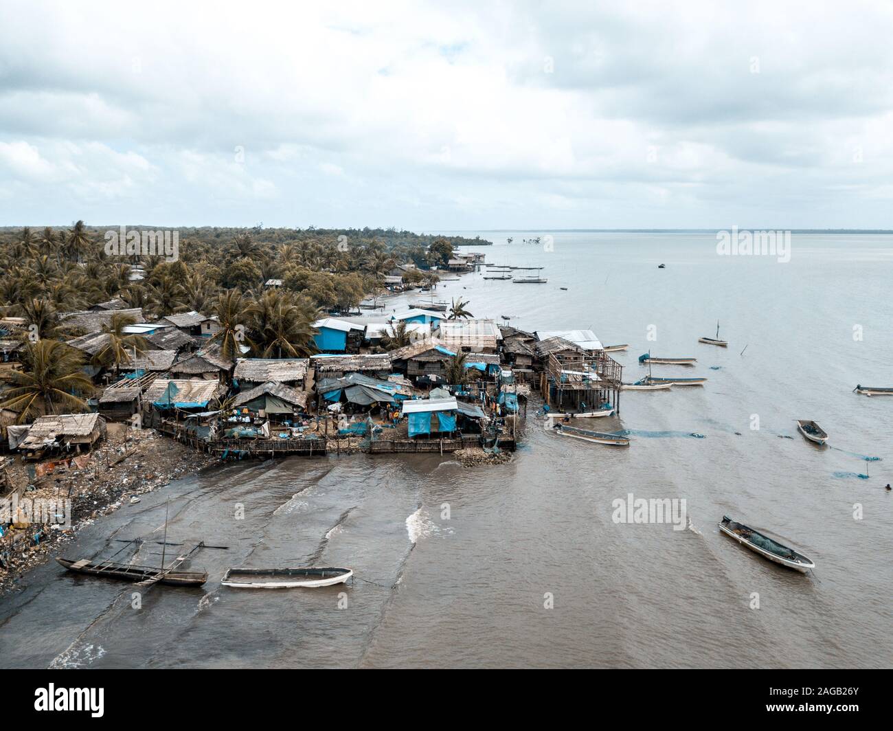 A high angle shot of buildings near the boats on the sea under a blue ...