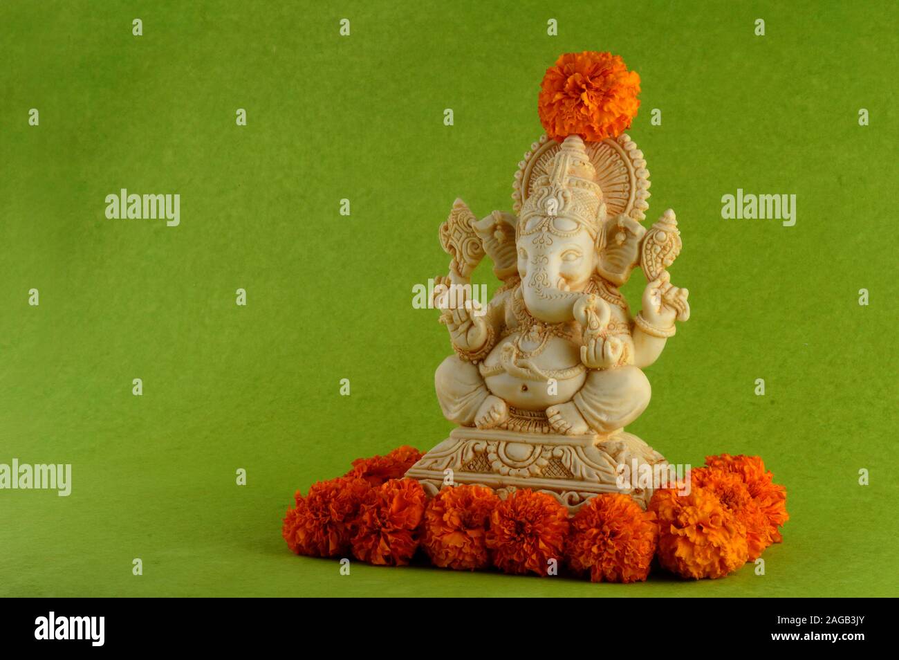 Hindu God Ganesha. Ganesha Idol on green background Stock Photo - Alamy