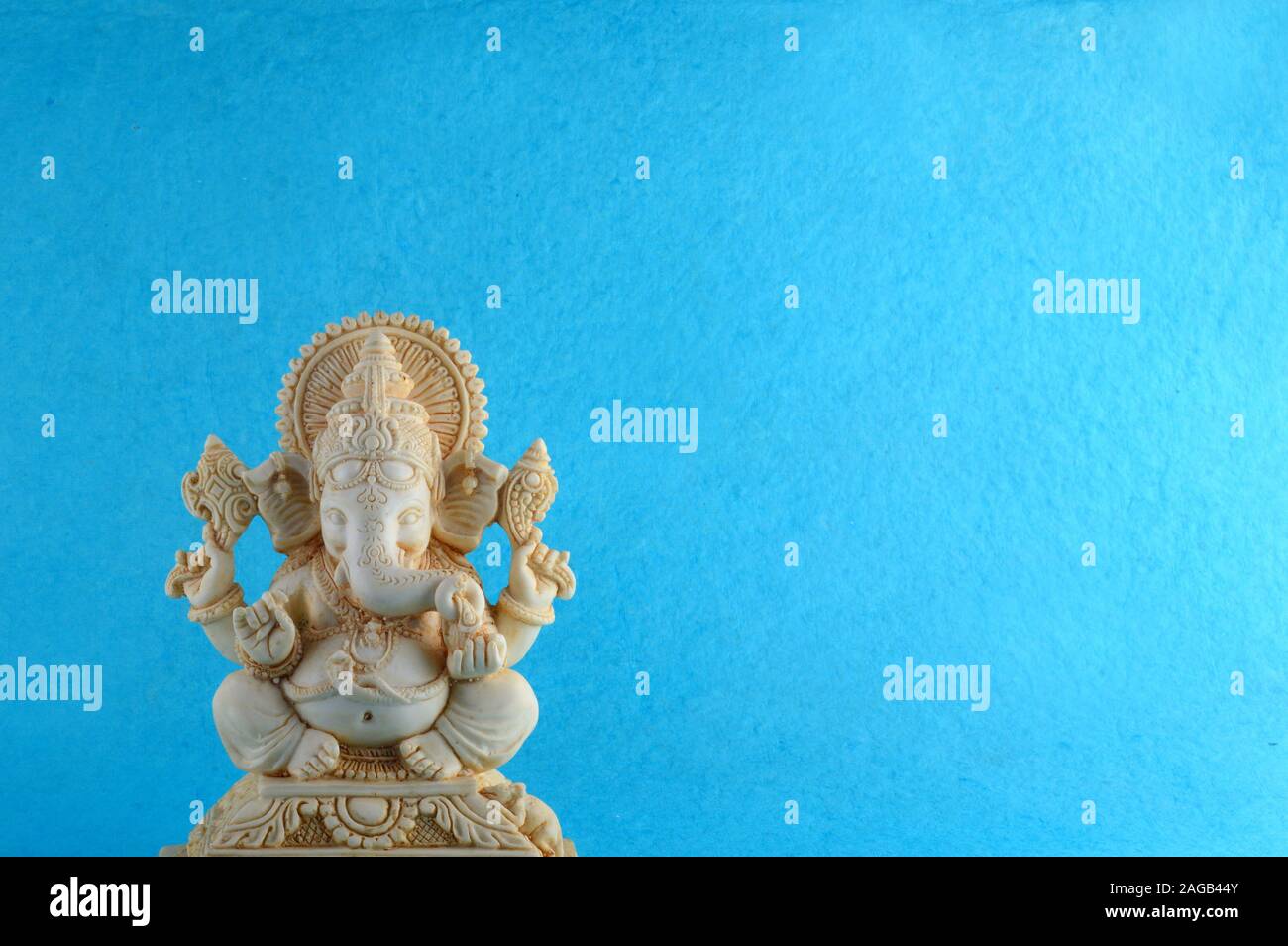 Hindu God Ganesha. Ganesha Idol on blue background Stock Photo - Alamy