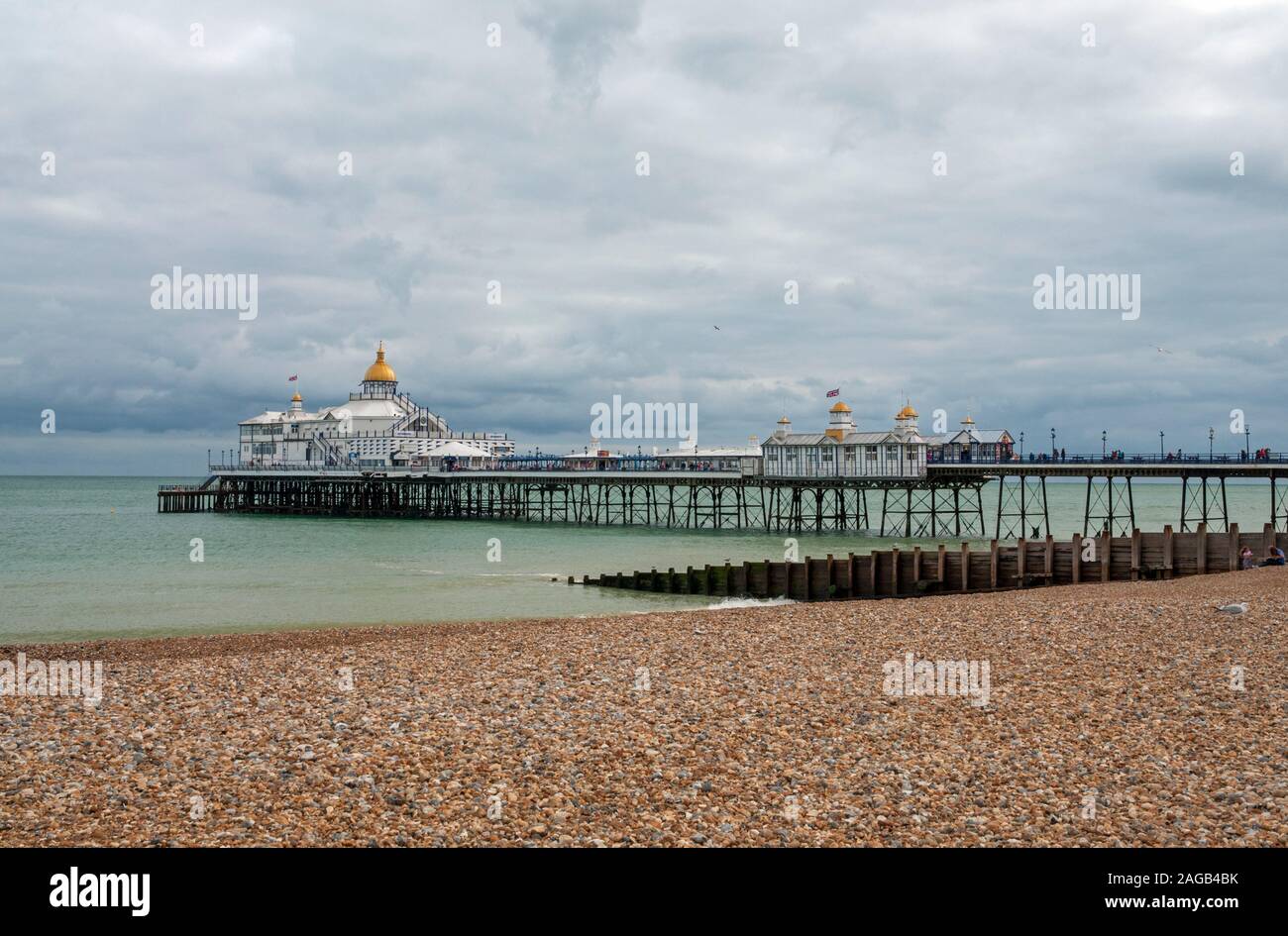 Eastbourne pebble beach with groyne and pier in the Summer, East Sussex ...