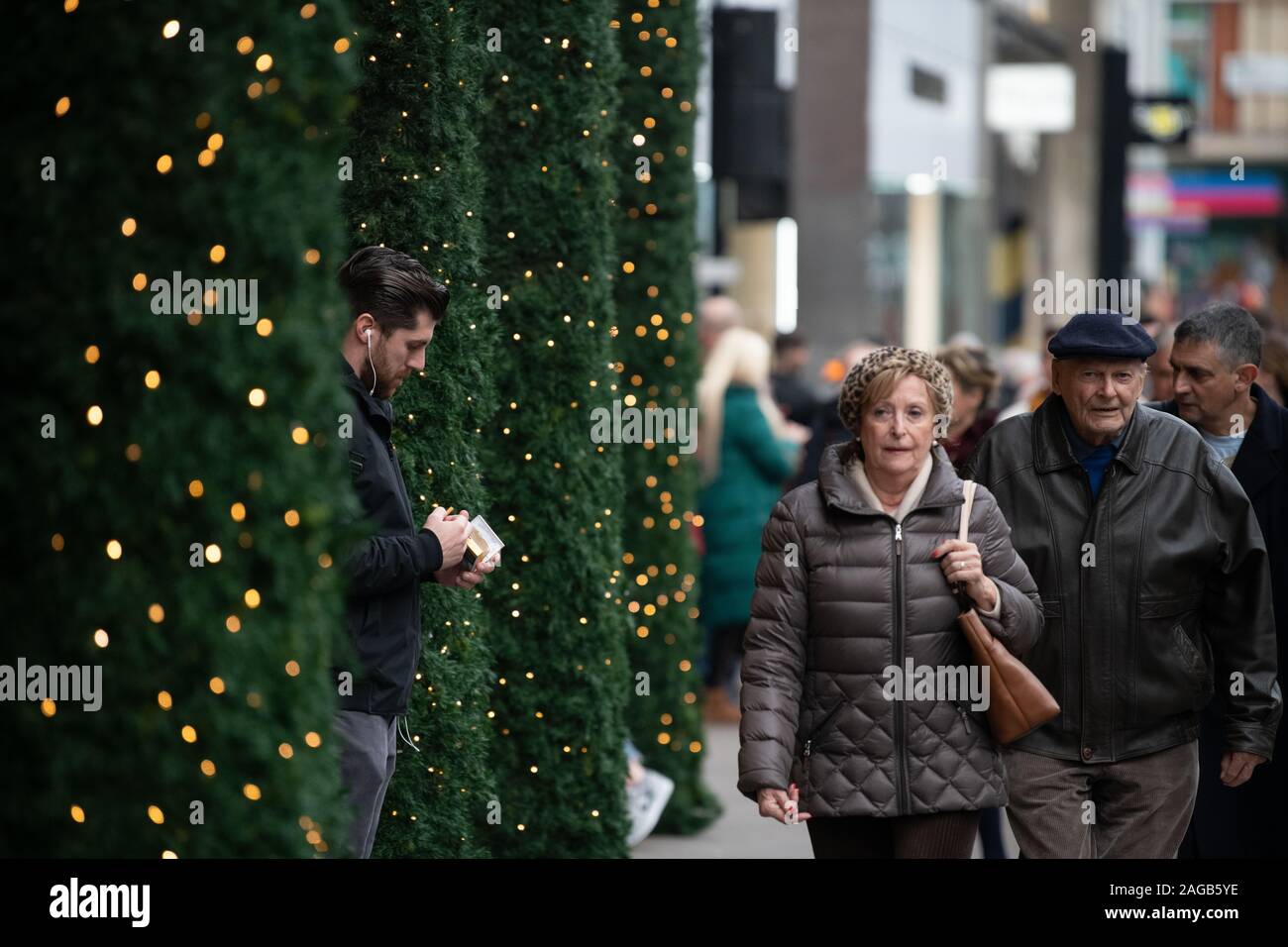 Man outside Selfridges before Christmas, taking a cigarette out of the ...