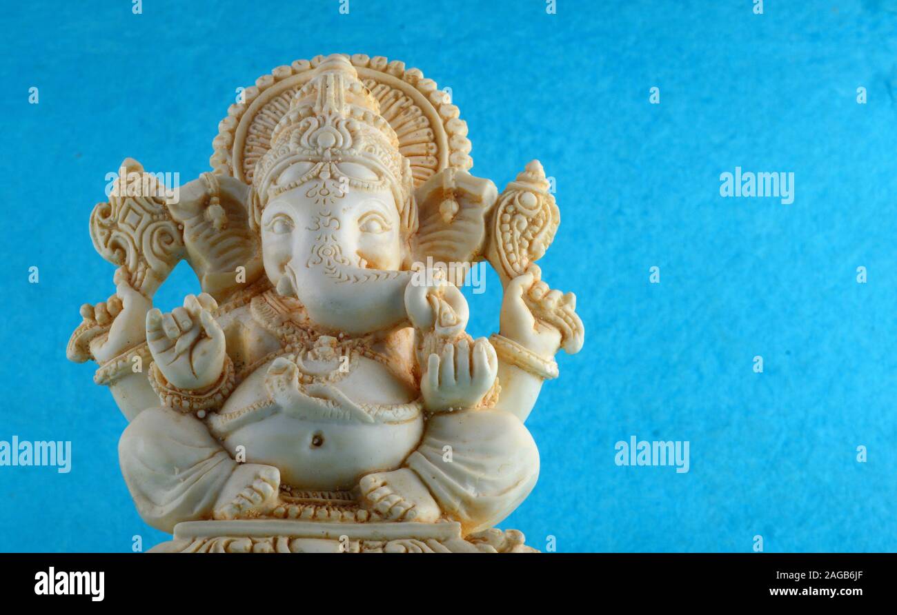 Hindu God Ganesha. Ganesha Idol on blue background Stock Photo - Alamy