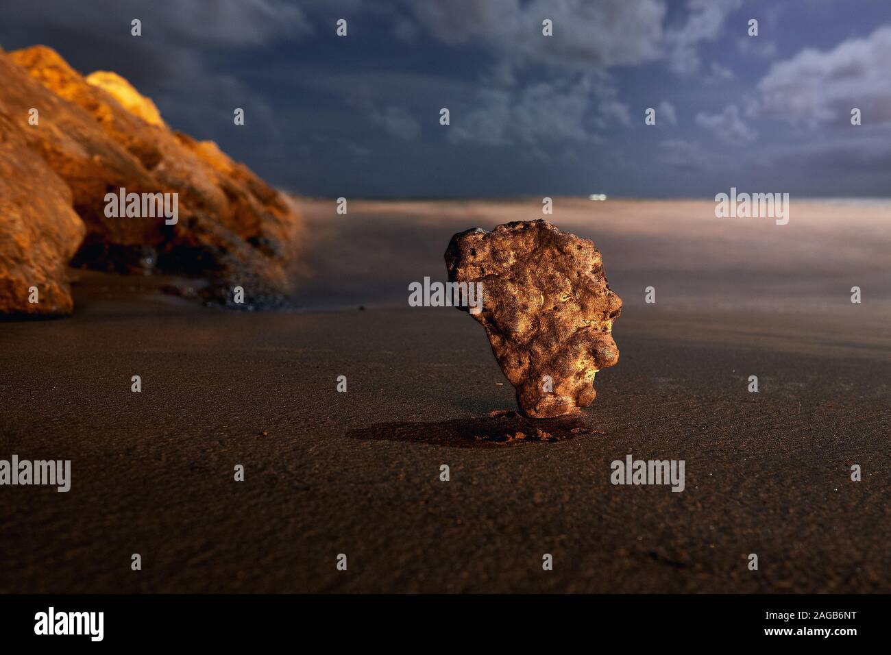 shell shaped rock encrusted on the sand of the beach at night Stock ...