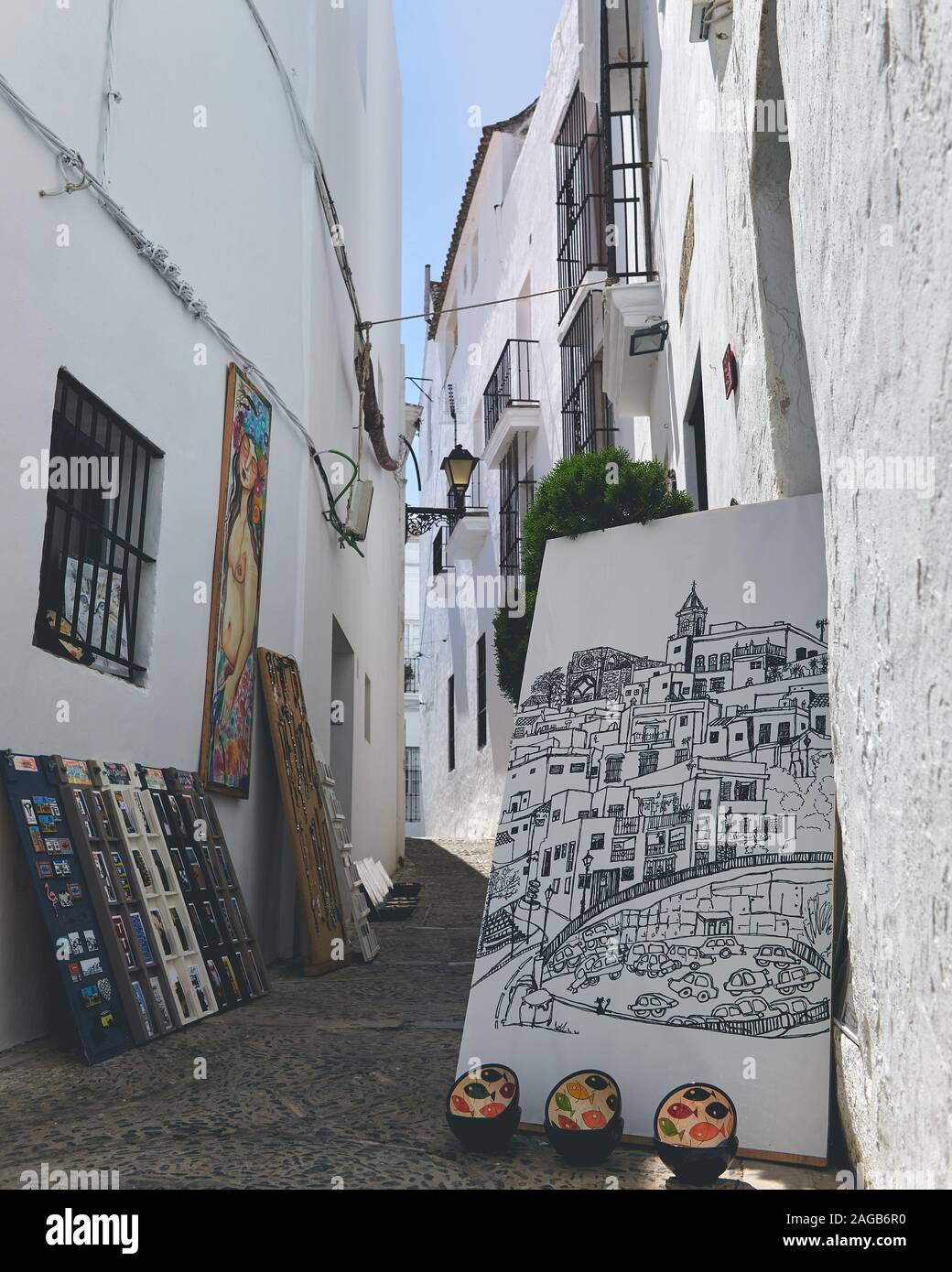 Street showcase of art with a painting of Vejer de la Frontera town ...
