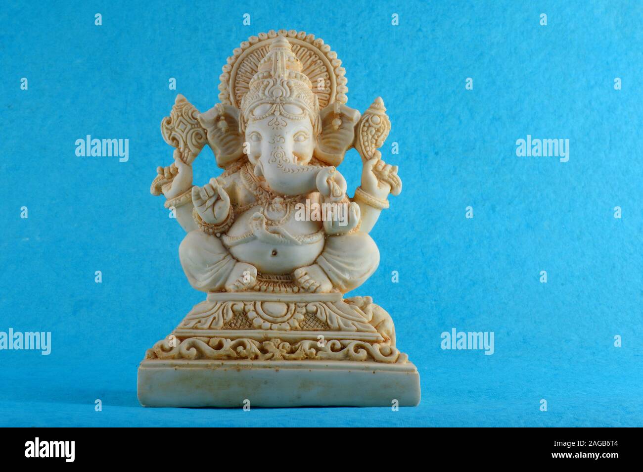 Hindu God Ganesha. Ganesha Idol on blue background Stock Photo - Alamy