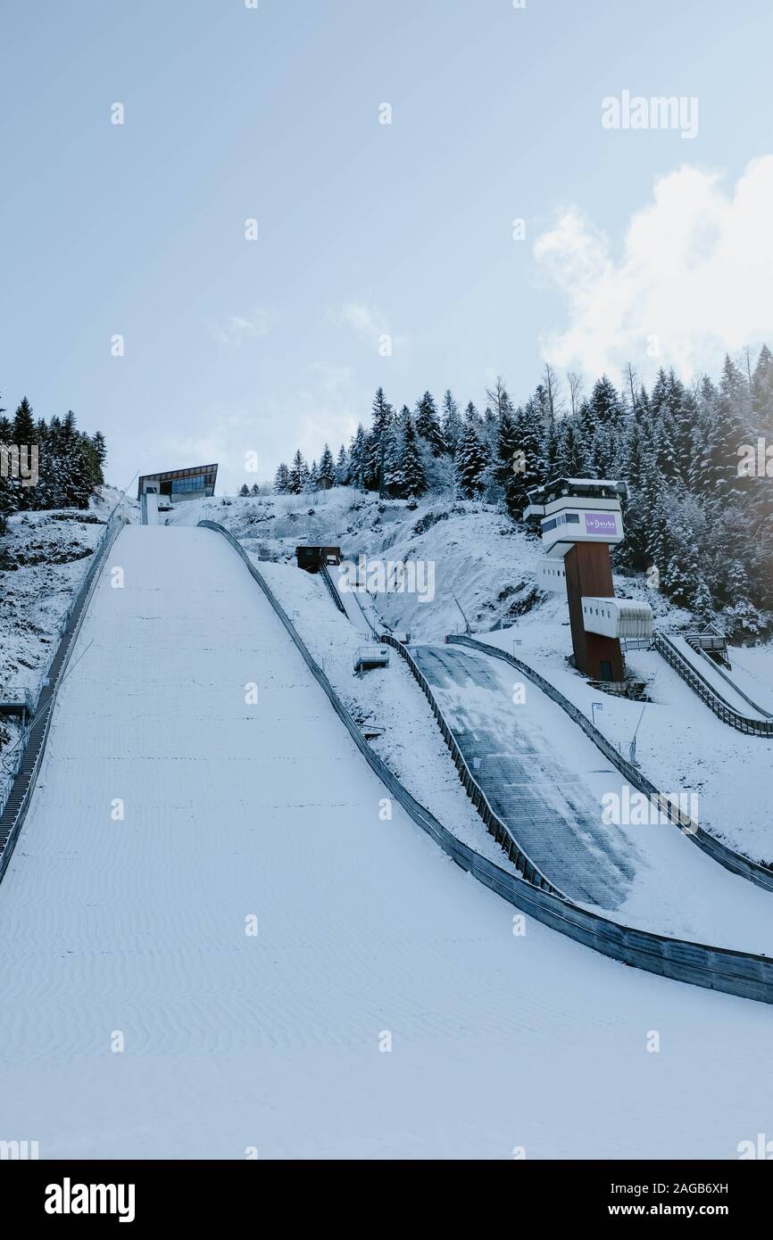 Vertical shot of the beautiful snow covered ski slope surrounded by ...