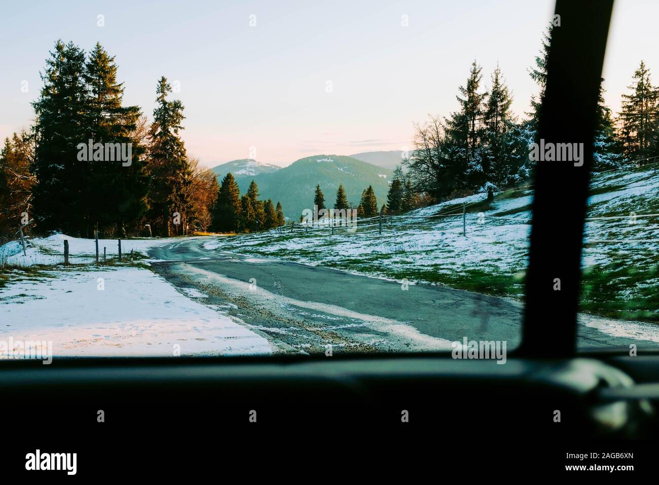 Beautiful view of a road going through snow covered fields with trees ...