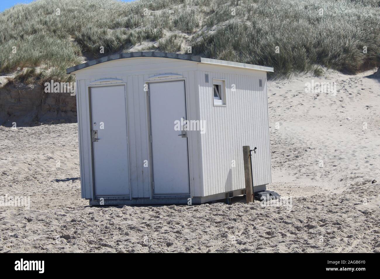Small modern hut located in the sandy wild shore Stock Photo - Alamy