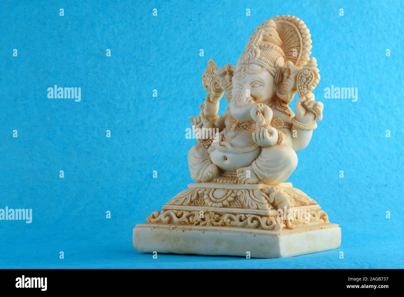 Hindu God Ganesha. Ganesha Idol on blue background Stock Photo - Alamy