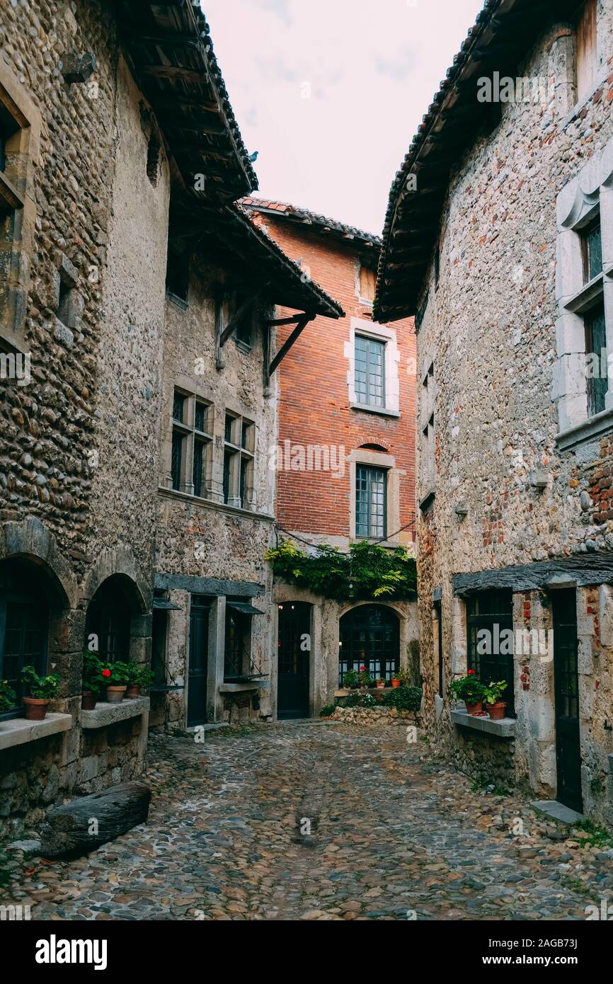 Vertical shot of a paved alley with beautiful old buildings Stock Photo ...