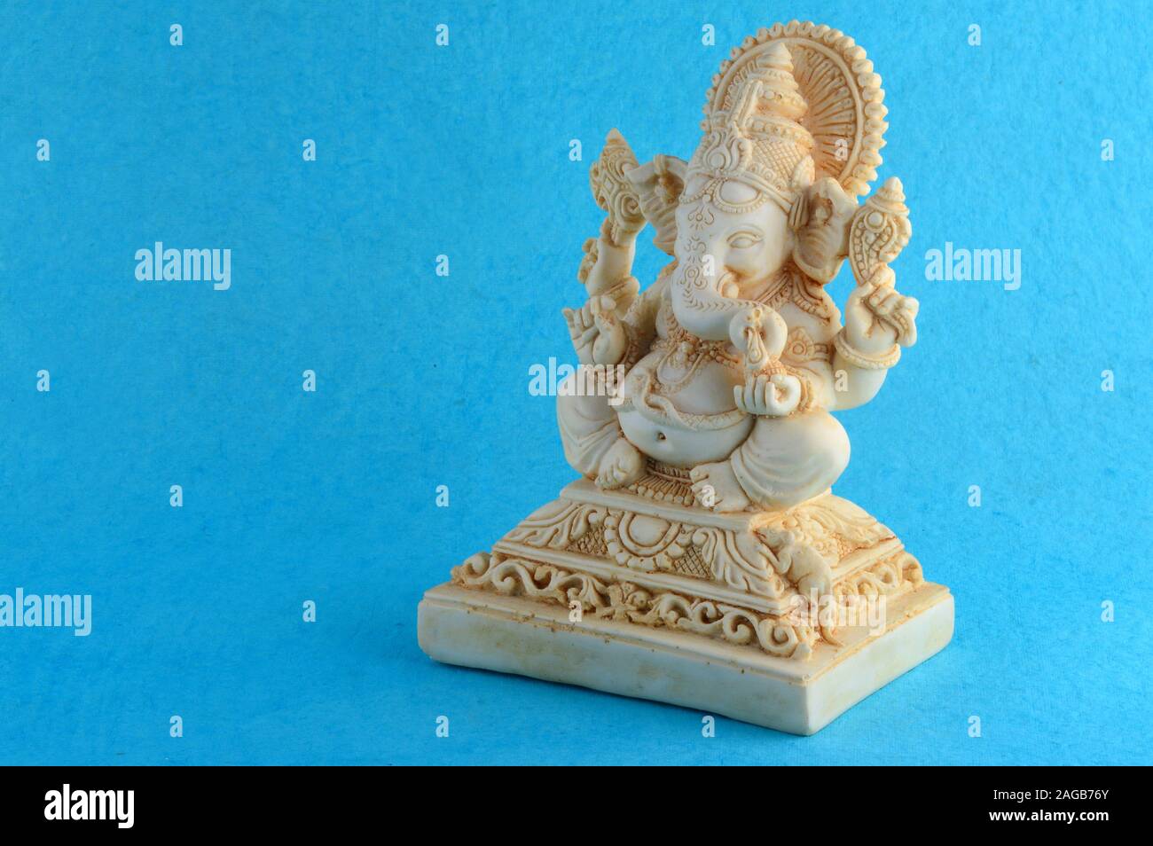 Hindu God Ganesha. Ganesha Idol on blue background Stock Photo - Alamy