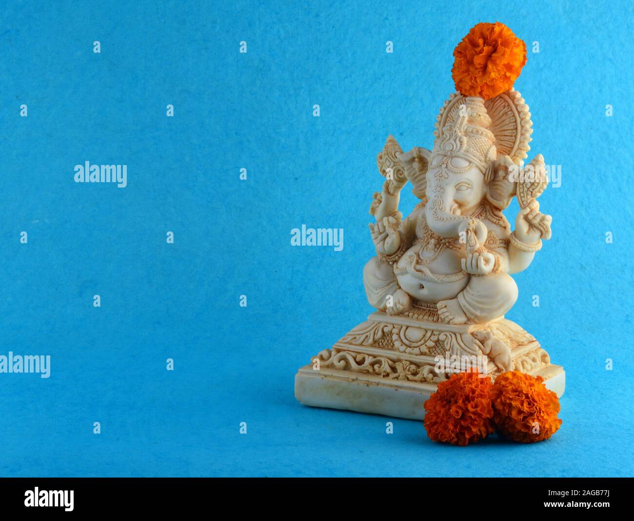 Hindu God Ganesha. Ganesha Idol on blue background Stock Photo - Alamy