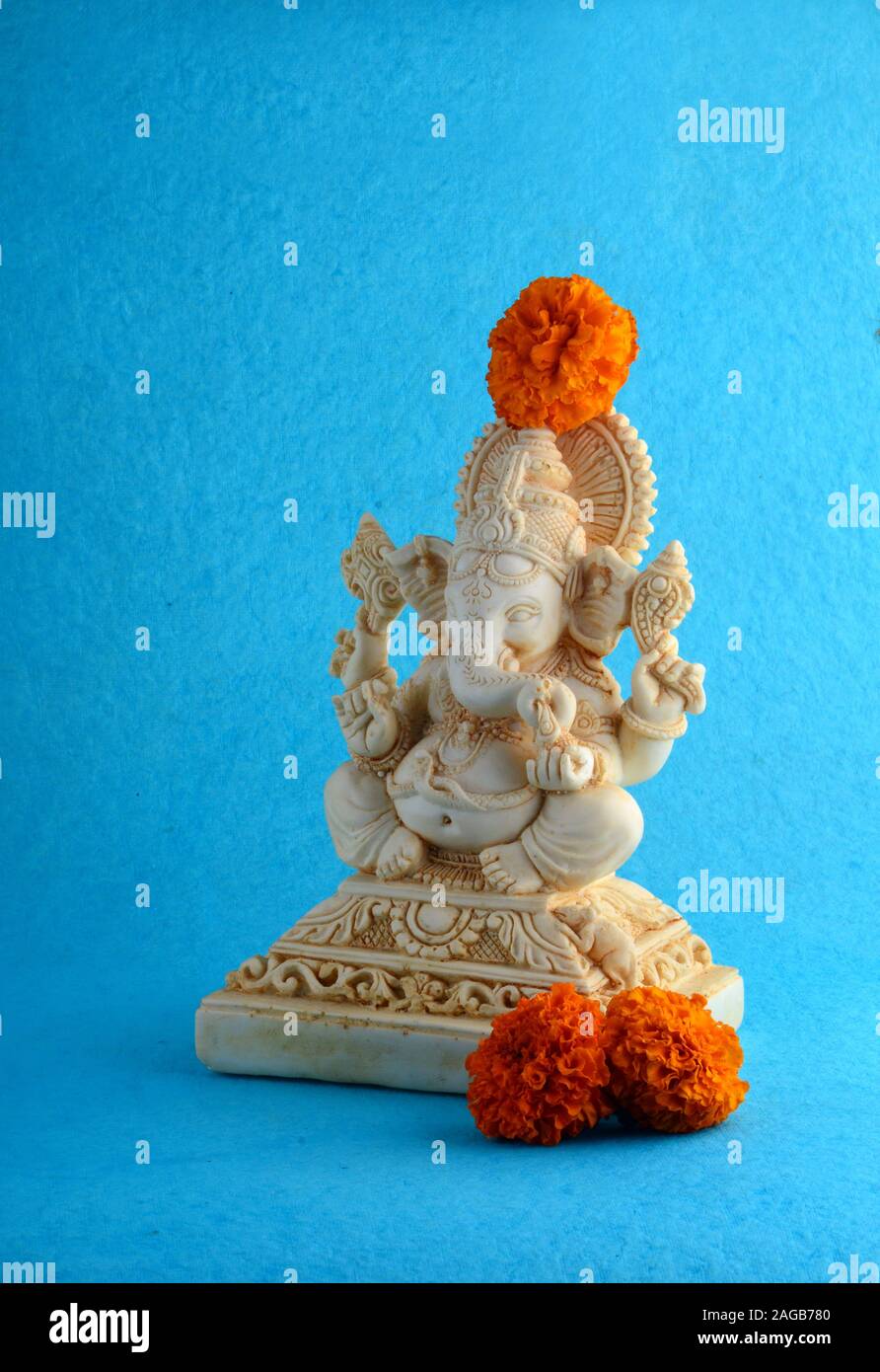 Hindu God Ganesha. Ganesha Idol on blue background Stock Photo - Alamy