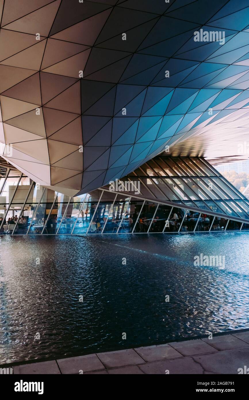 Vertical shot of a geometrical grey structure over a river Stock Photo ...