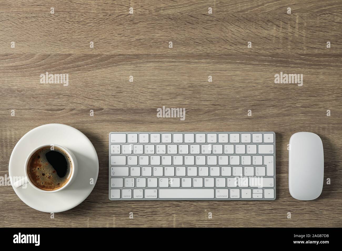 Workplace. Keyboard, mouse and cup of coffee on wooden background ...