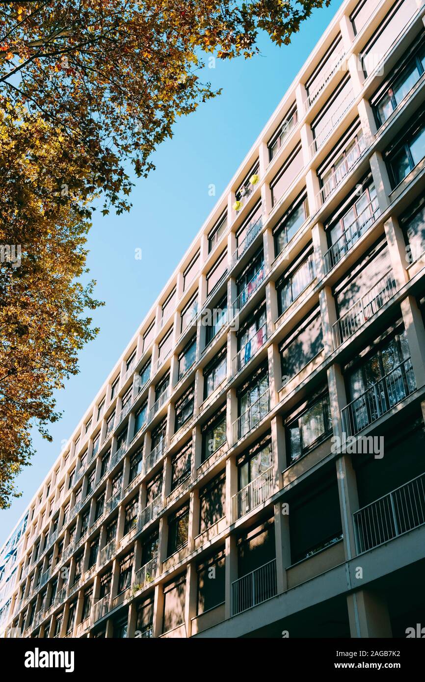 Vertical low angle shot of a big concrete building under the blue sky ...